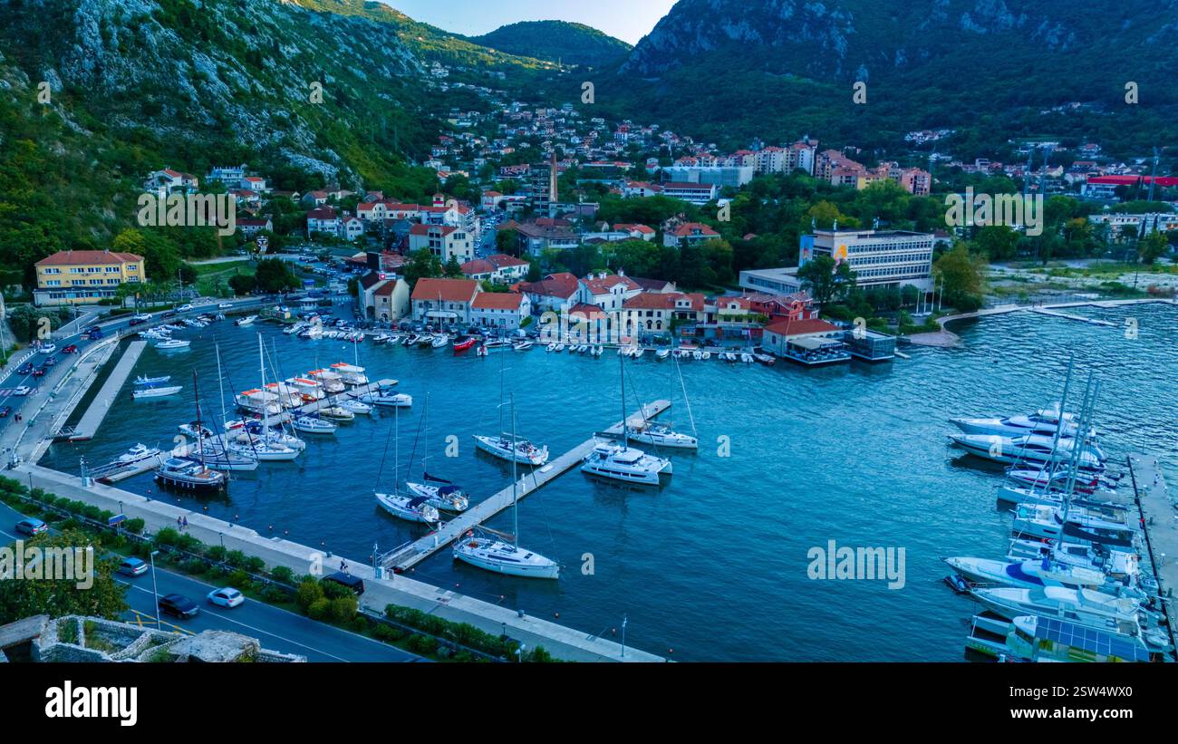 Explore the stunning harbor of Kotor, Montenegro at dusk with boats and ...