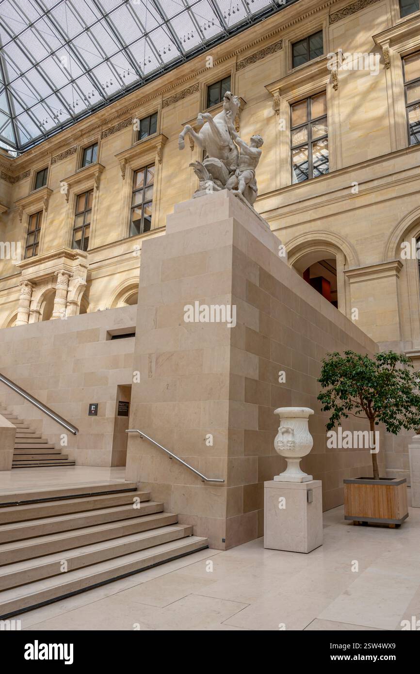Paris, France - 02 23 2022: Le Louvre Museum. Statues, trees on ...