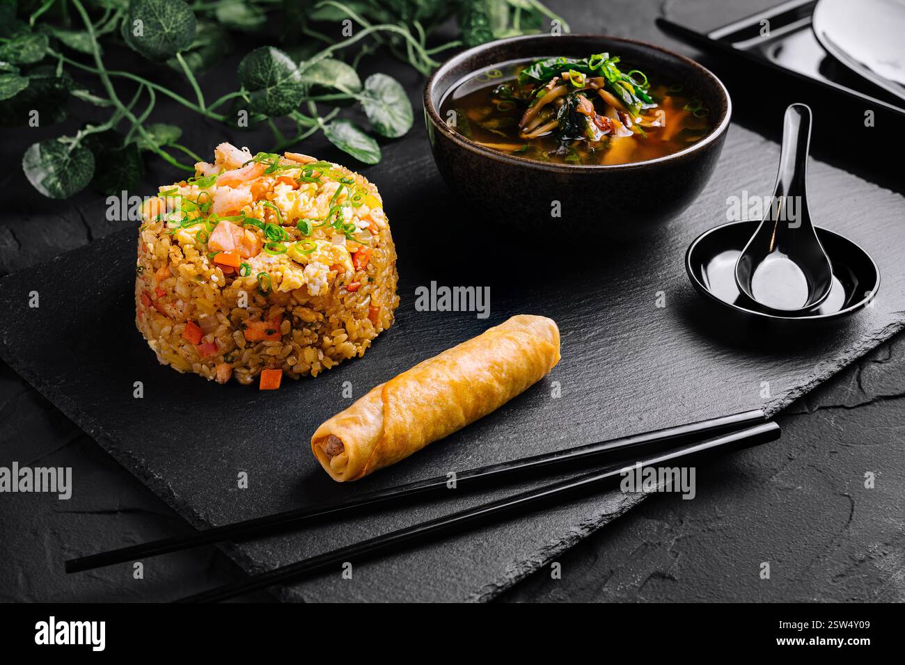 Asian cuisine delight: fried rice, spring roll, and soup Stock Photo ...