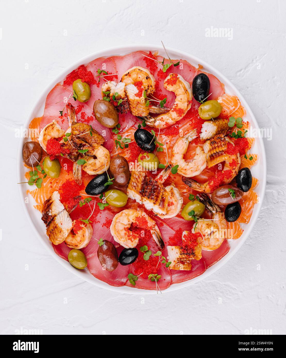 Top view of a delicious gourmet seafood dish with shrimp, caviar, and ...