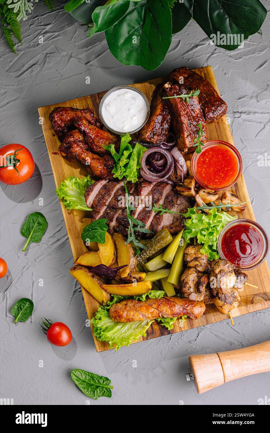 Assorted grilled meat and vegetable platter with sauces Stock Photo - Alamy