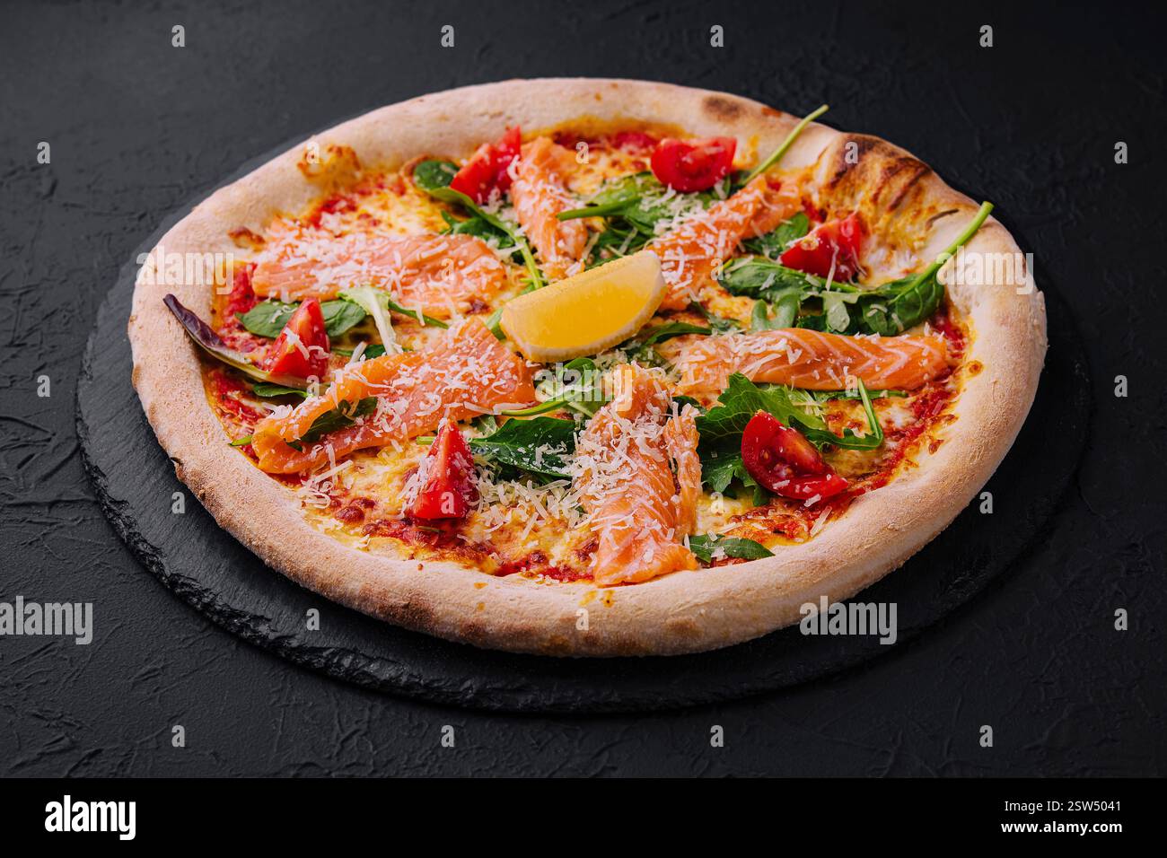 Gourmet smoked salmon pizza on dark background Stock Photo - Alamy