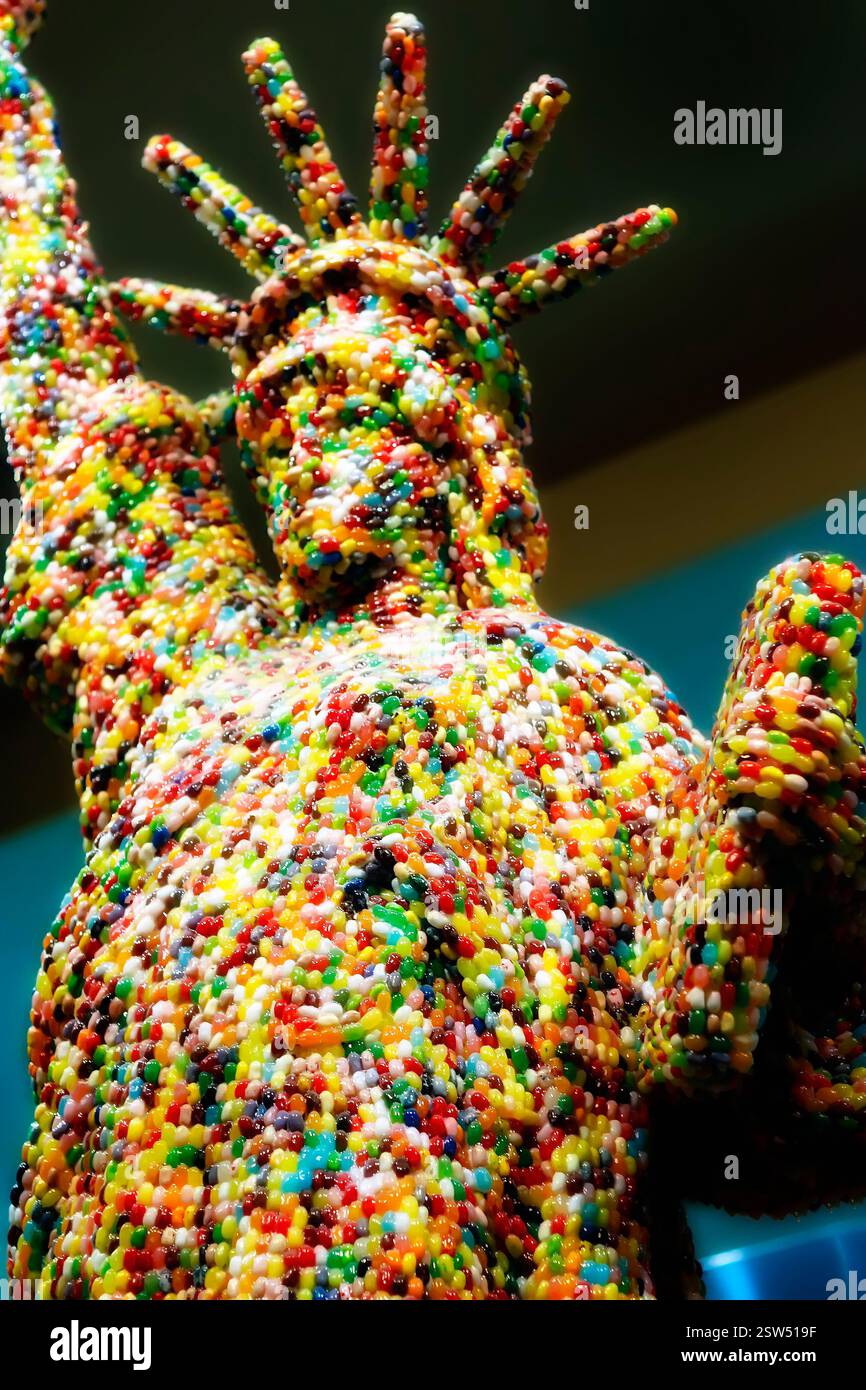 Statue of a woman made of jelly beans. The statue is colorful and has a ...