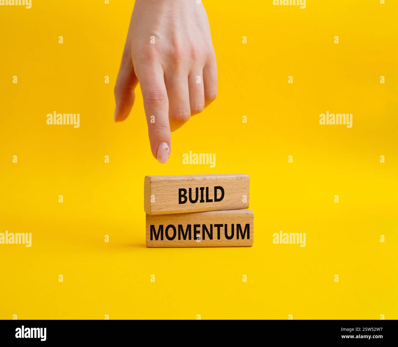 Build momentum symbol. Wooden blocks with words Build momentum ...