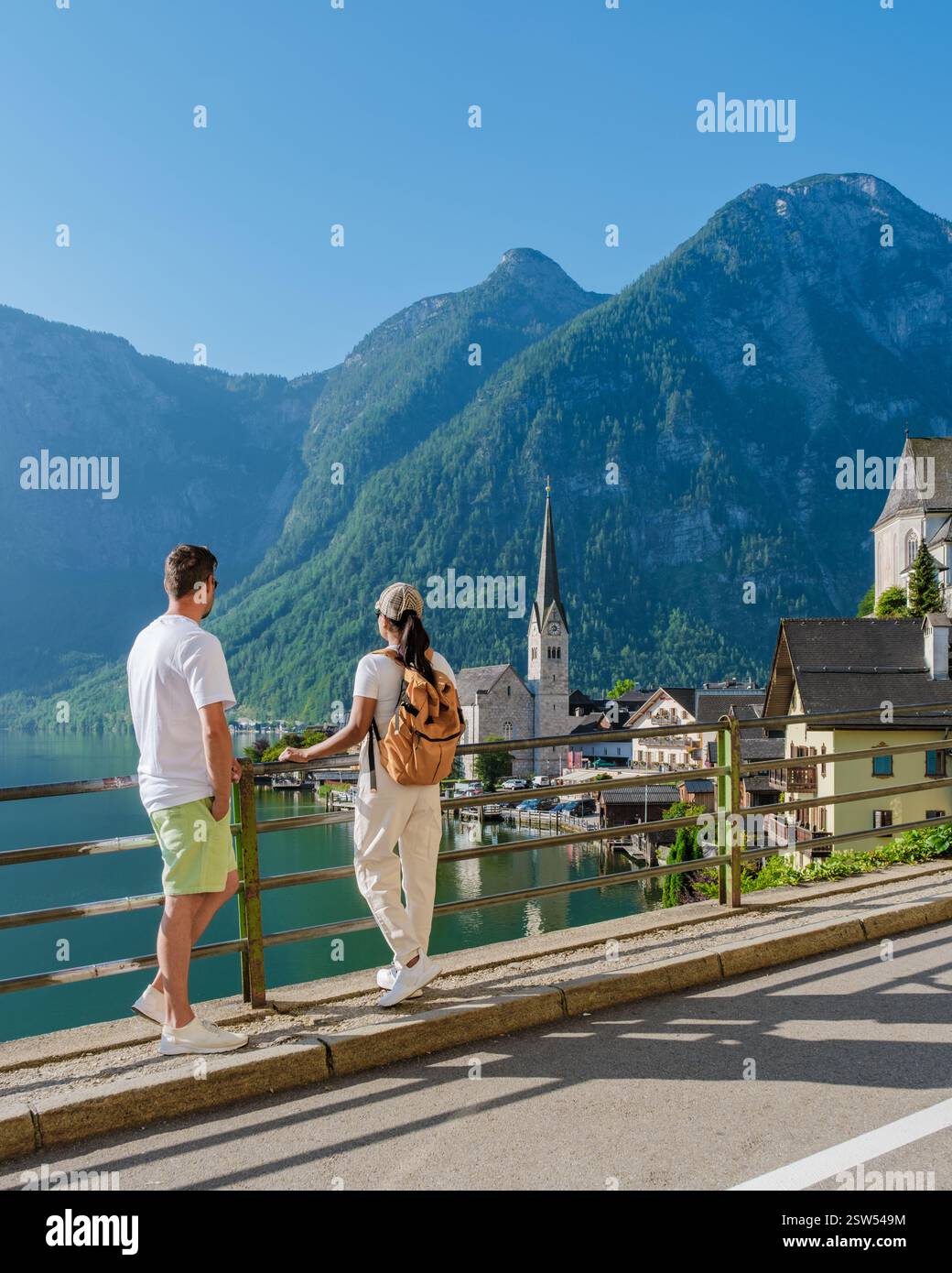 Exploring the breathtaking beauty of Hallstatt, Austria, as visitors admire stunning mountain ...