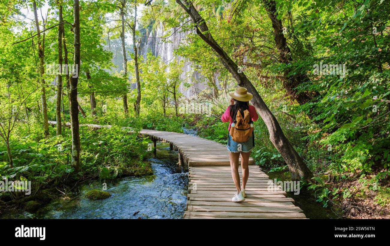 Wandering along wooden paths at Plitvice Lakes, a traveler enjoys the ...