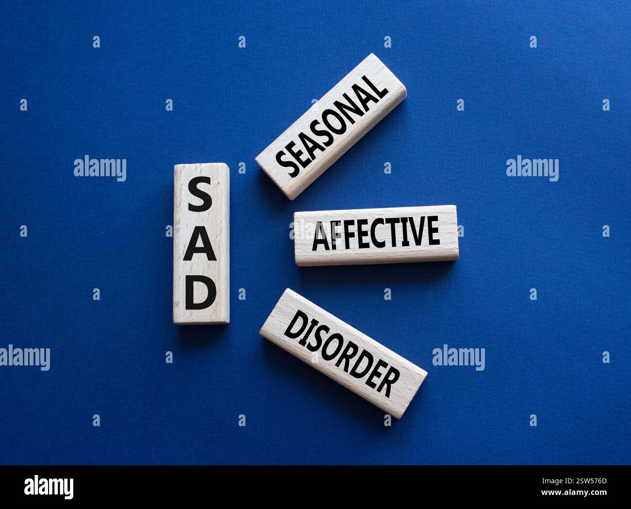 Sad - Seasonal Affective Disorder symbol. Wooden blocks with words Sad ...