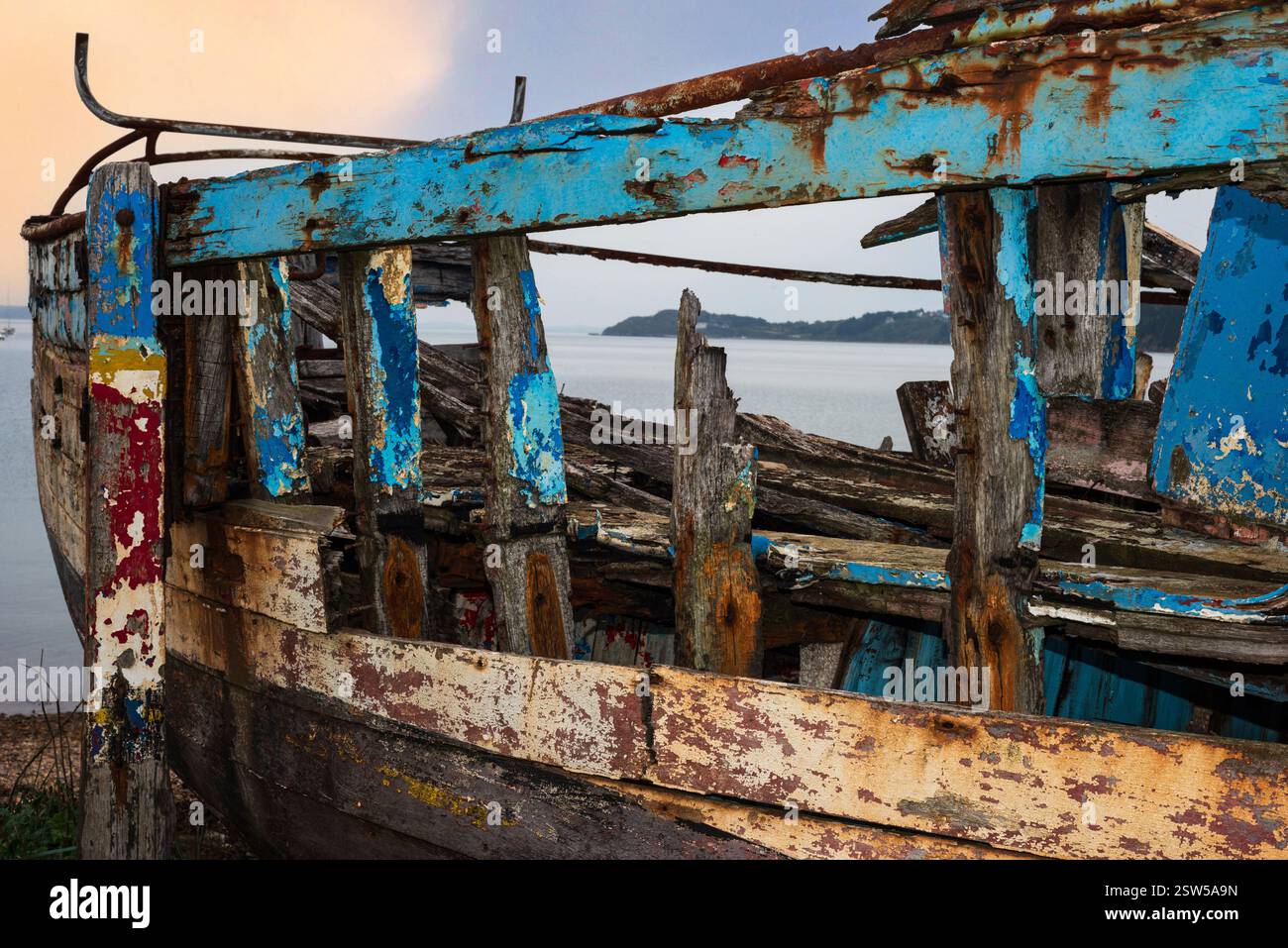 Hazy sunshine warms this view through the rotting ribs of an old ...