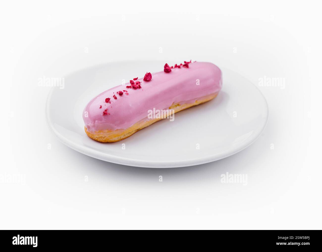 Pink iced eclair on white plate Stock Photo - Alamy
