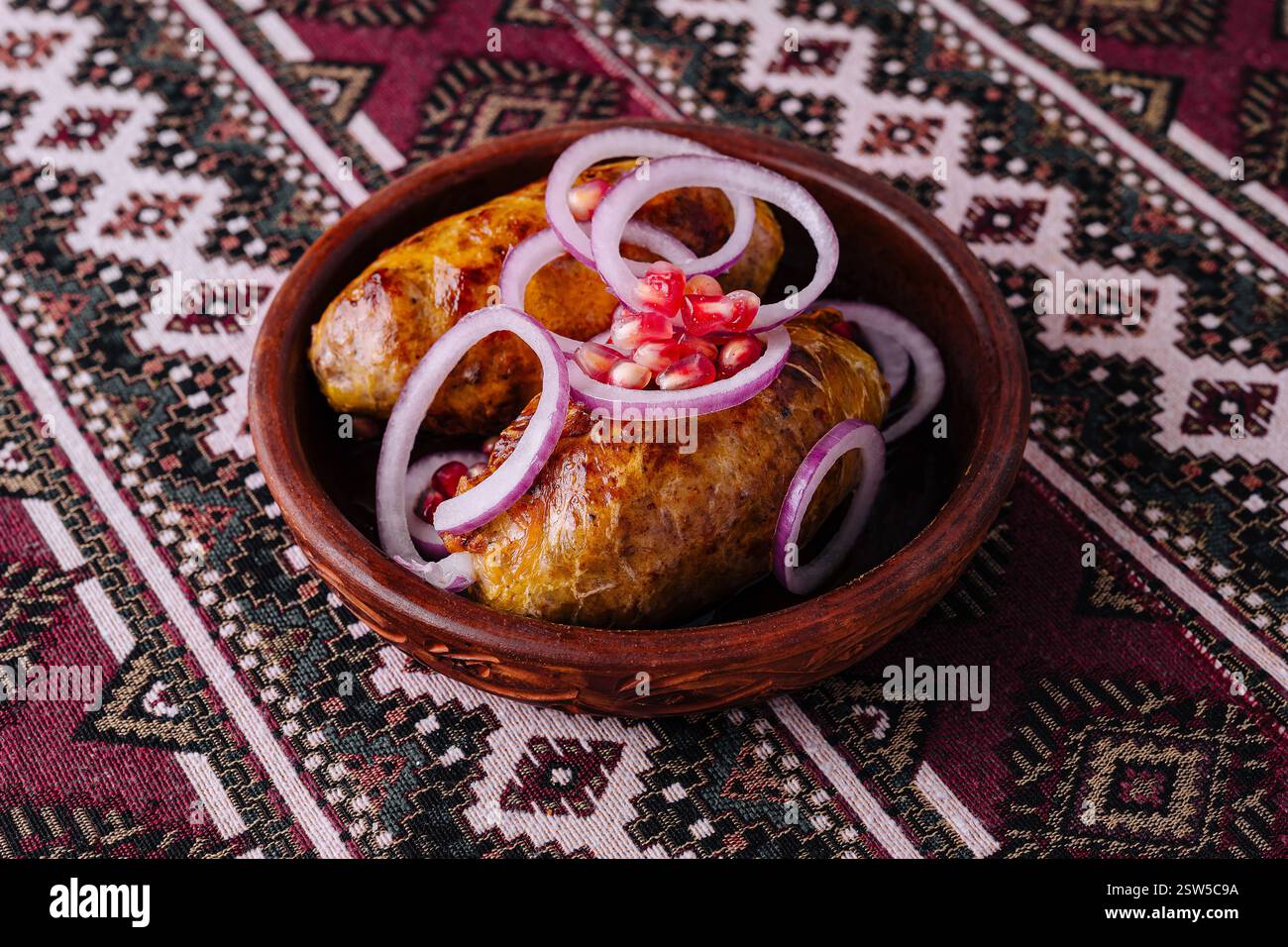 Traditional georgian dish shkmeruli in ceramic bowl Stock Photo - Alamy