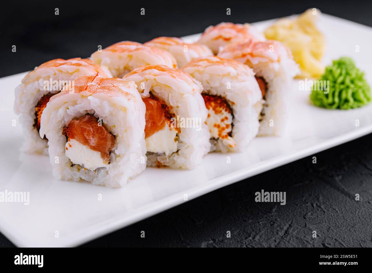 Tempting shrimp sushi roll served with wasabi and ginger on a sleek ...