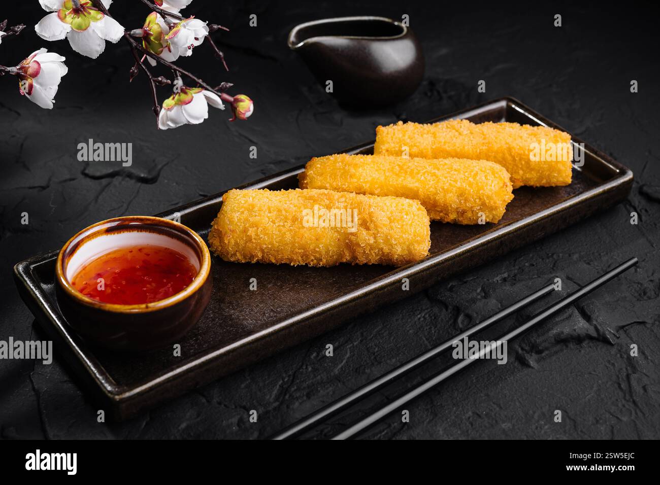 Crispy fried fish rolls with sweet chili sauce Stock Photo - Alamy