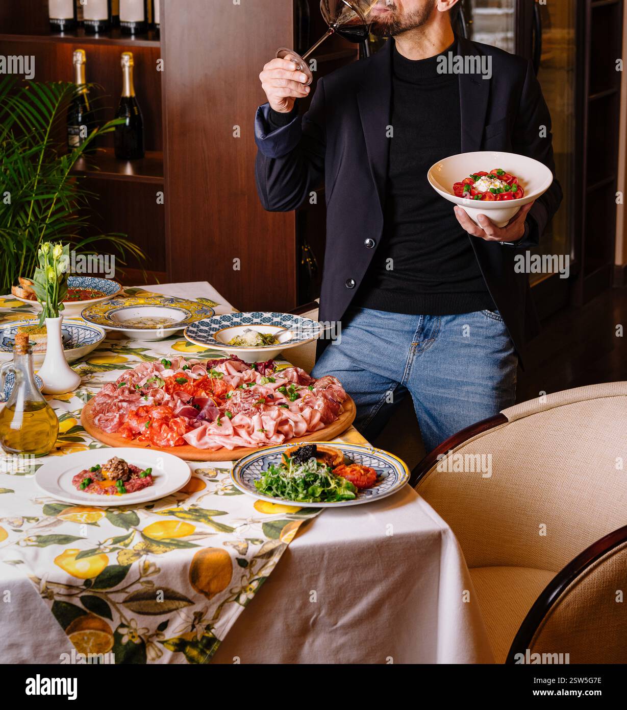 Man enjoying a feast of italian dishes Stock Photo - Alamy