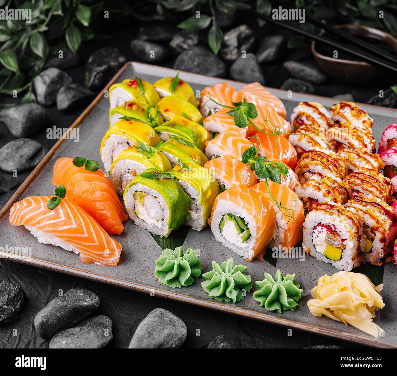Vibrant selection of sushi and rolls served on a modern plate with ...