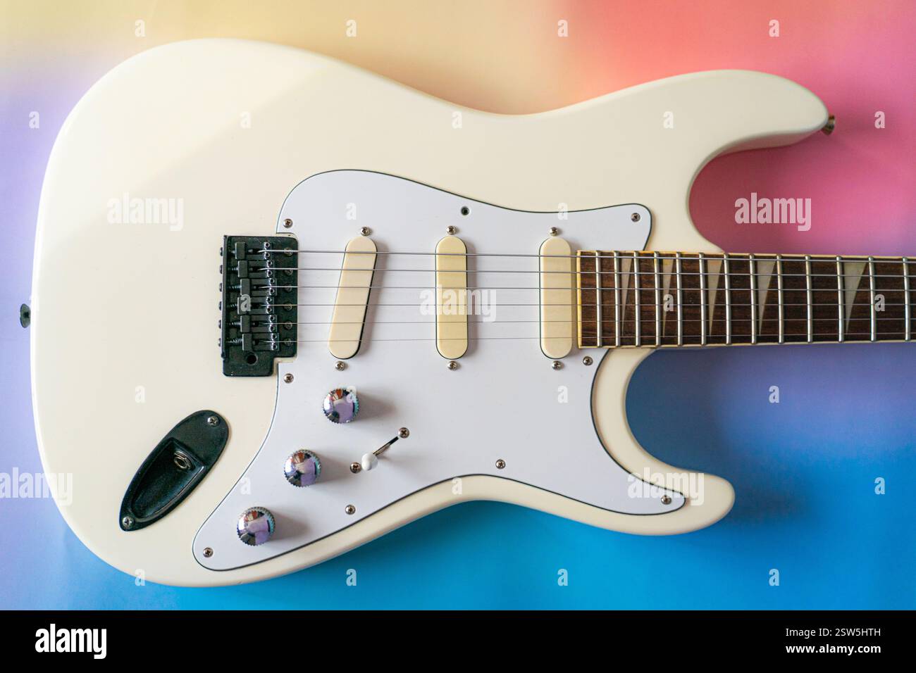 White electric guitar with a classic double cutaway design. On a ...