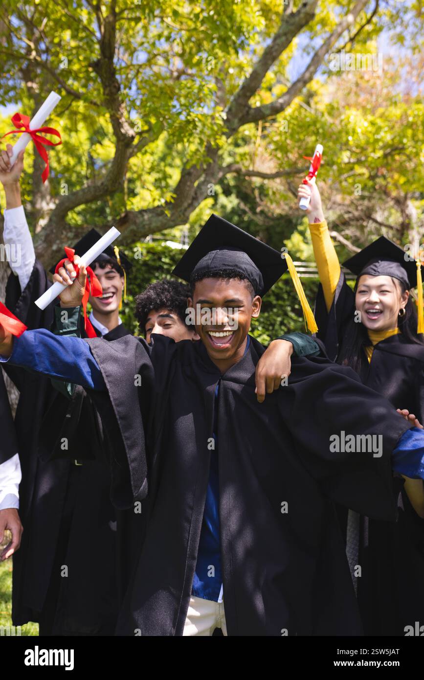 Four young multiracial adults wearing hi-res stock photography and ...