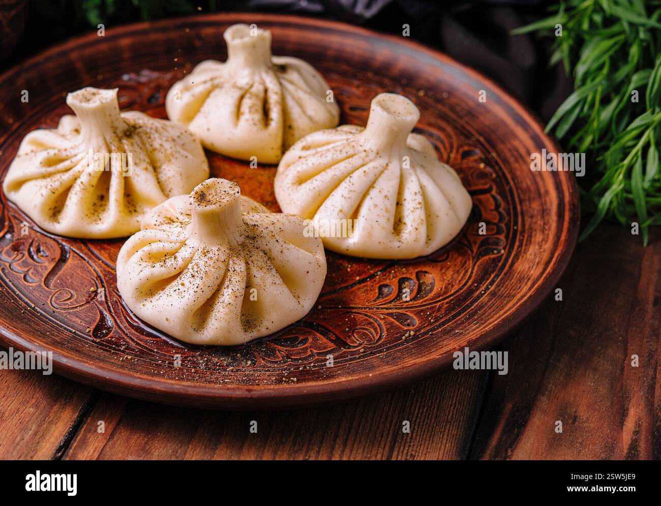 Georgian khinkali on traditional plate Stock Photo - Alamy