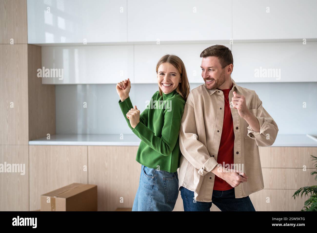 Happy family couple in new home with unpacked cardboard boxes ...