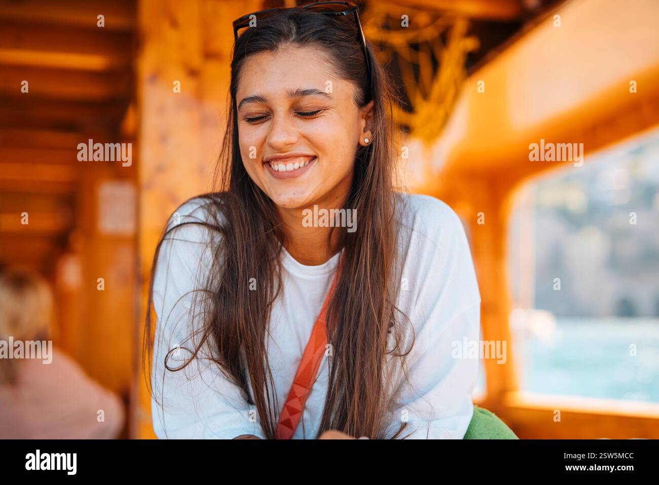 A joyful woman beams with happiness on a delightful boat ride ...