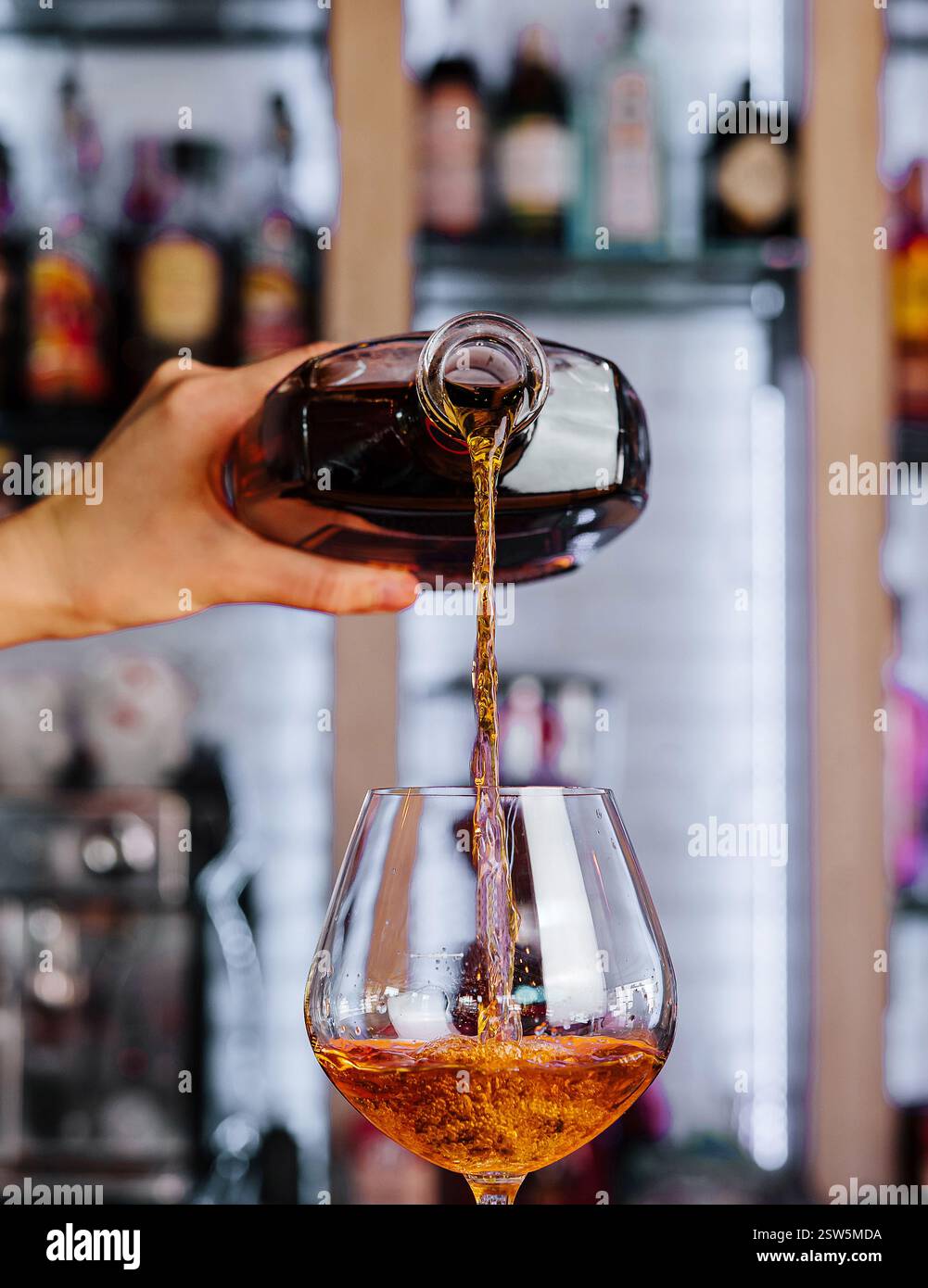 Pouring whiskey into glass at bar Stock Photo - Alamy