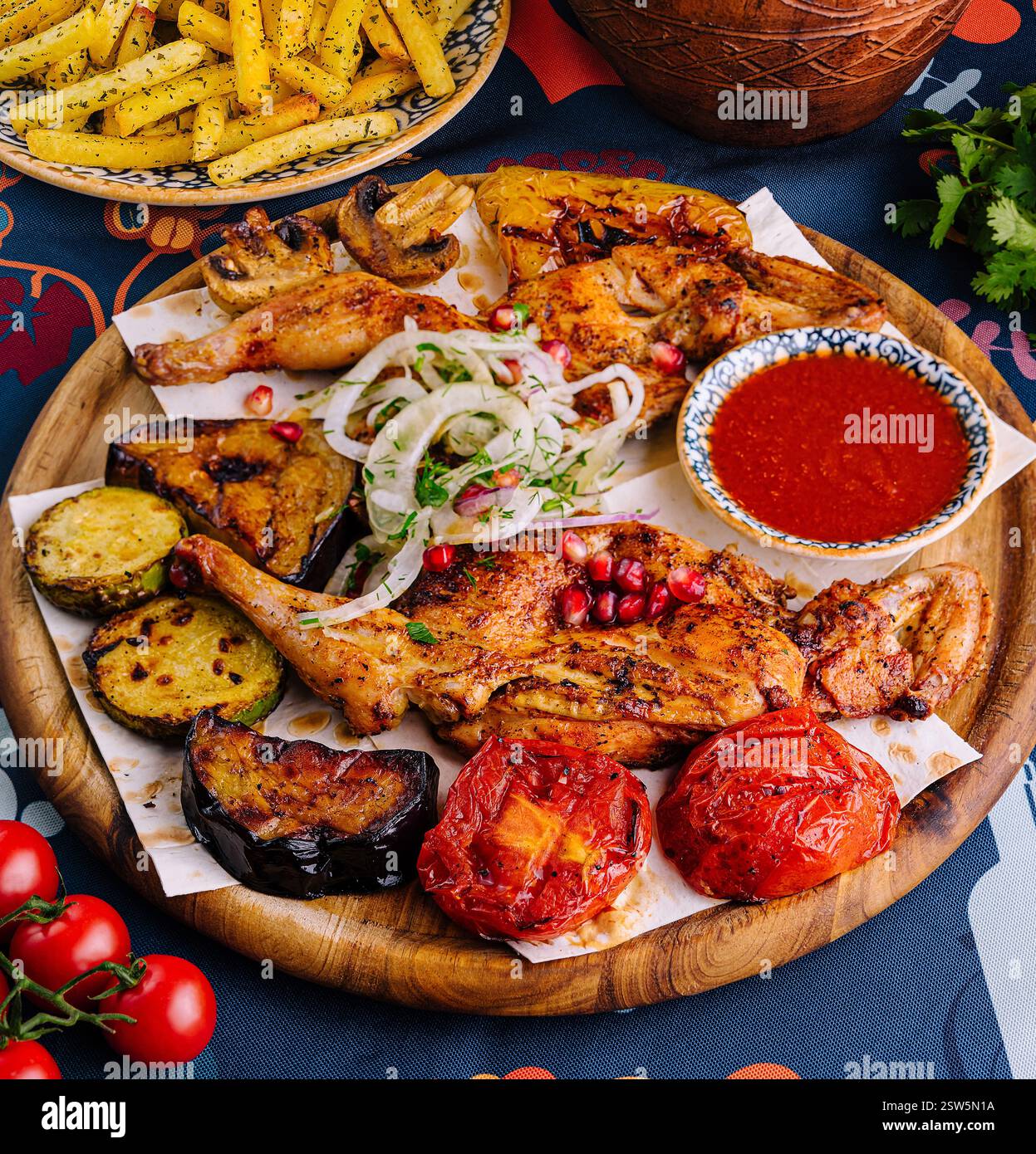 Traditional grilled chicken platter with vegetables and spices Stock ...