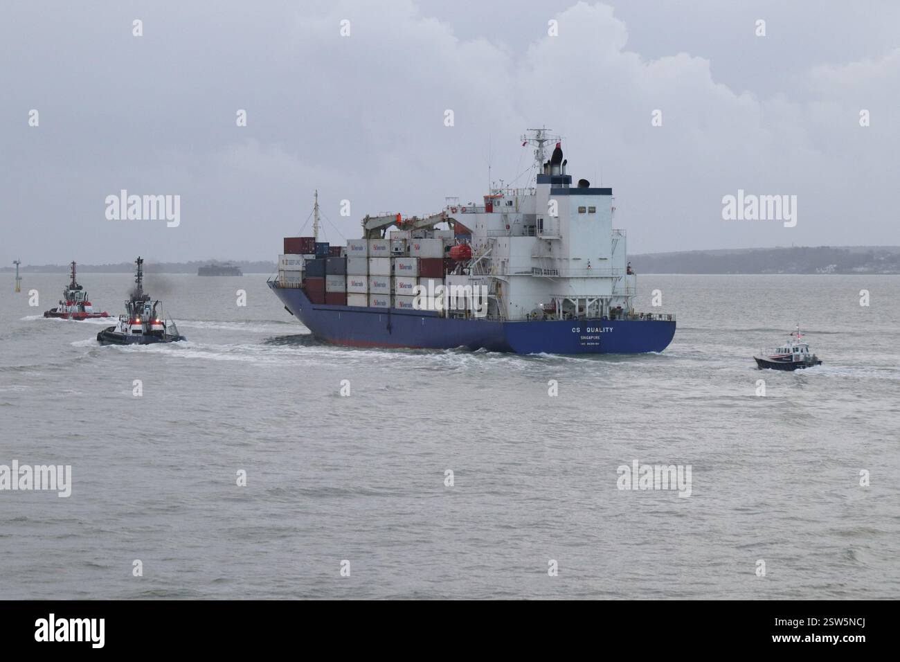 Tugs escort the Singapore registered refrigerated cargo ship MV CS ...