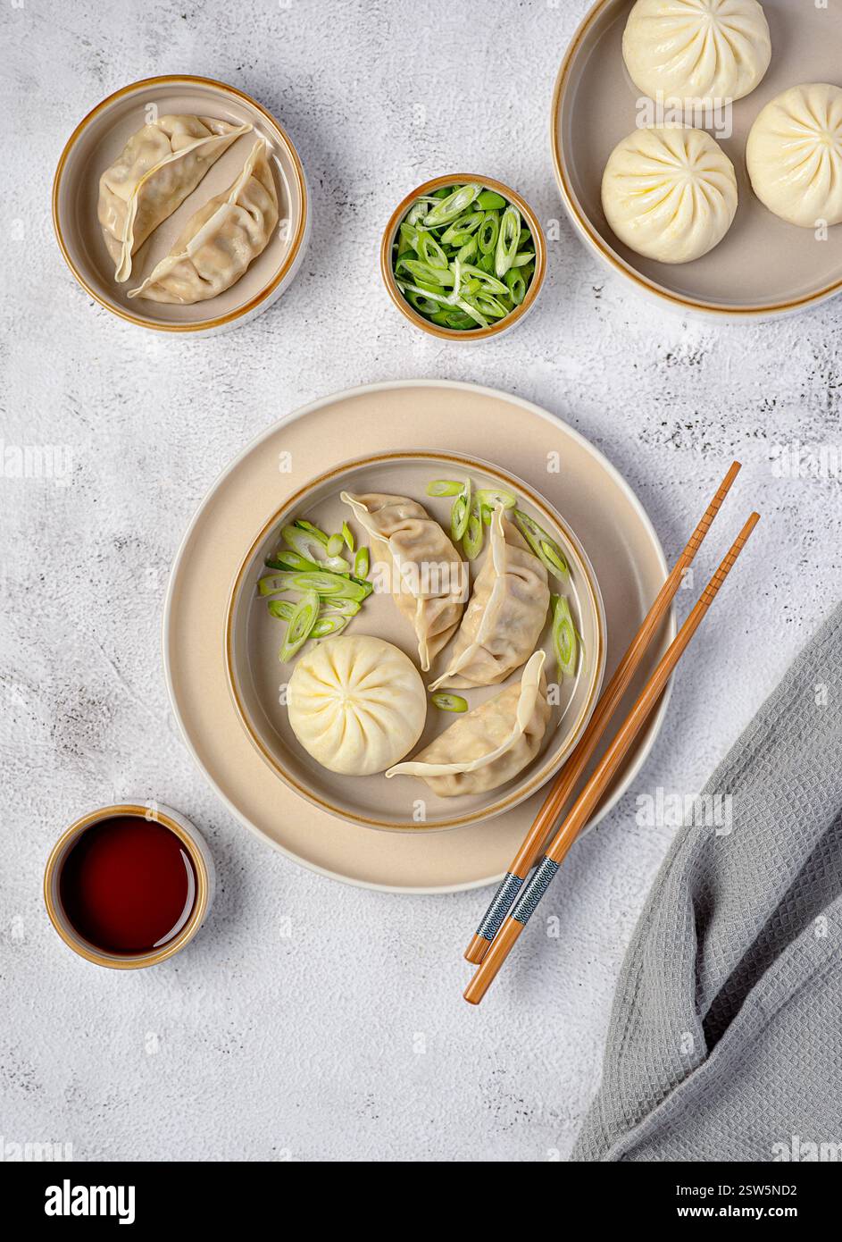 Food photography of steamed duck bao buns and chicken gyoza, spring ...