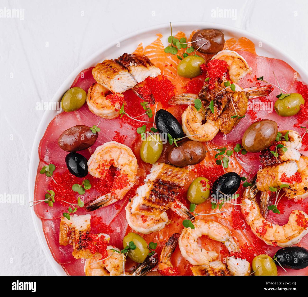 Top view of a delicious gourmet seafood dish with shrimp, caviar, and ...