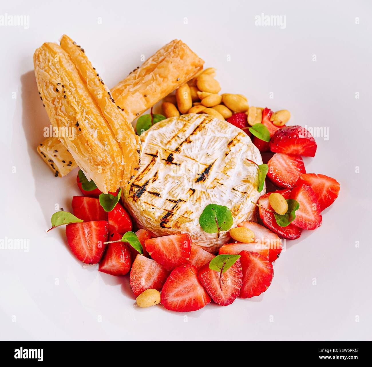 Top-view of a beautifully plated bbq cheese with strawberries and puff ...