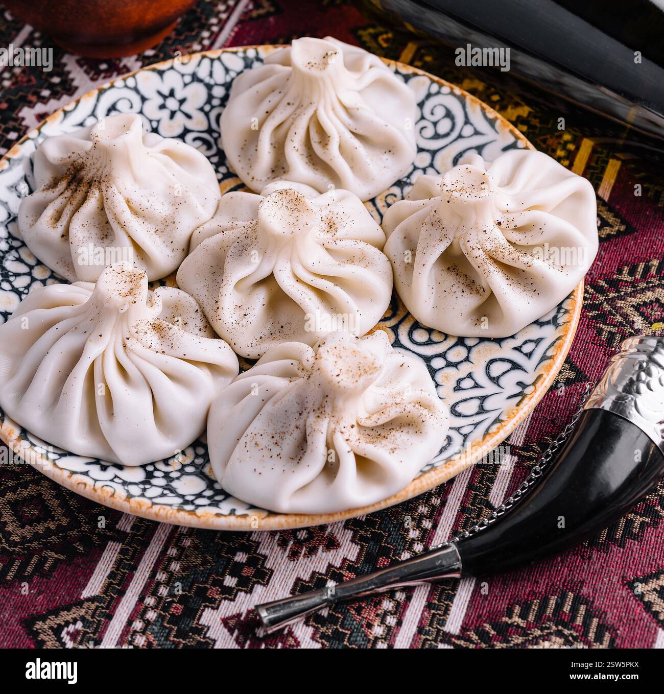 Georgian dumplings khinkali on traditional plate Stock Photo - Alamy