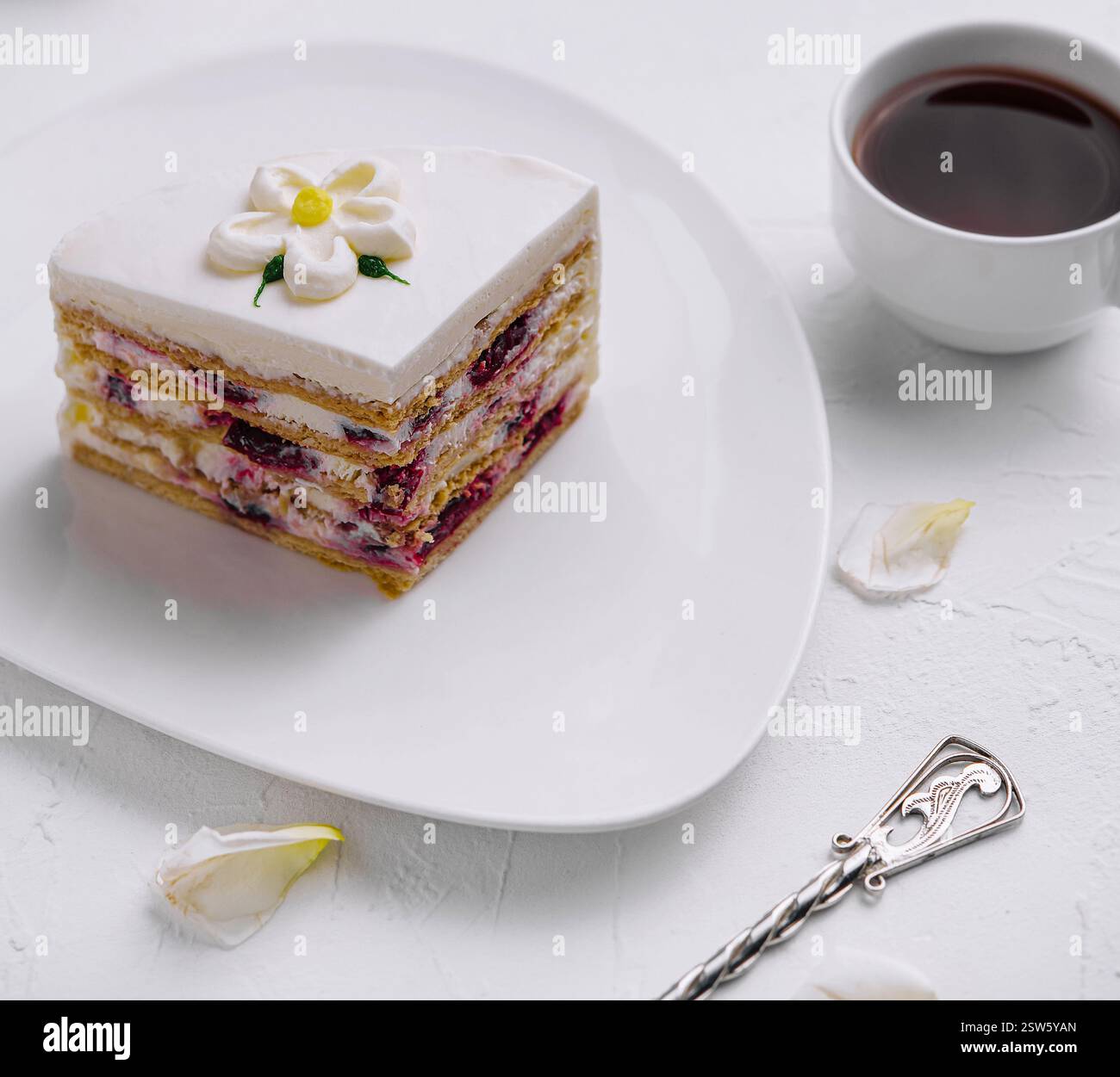 Elegant white layered cake with floral decorations Stock Photo - Alamy