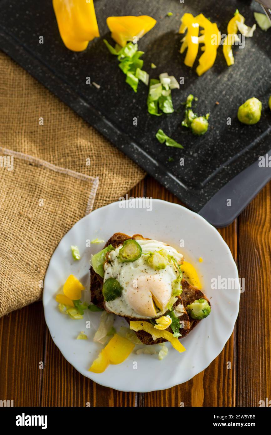 Egg on bread with vegetable garnish Stock Photo - Alamy