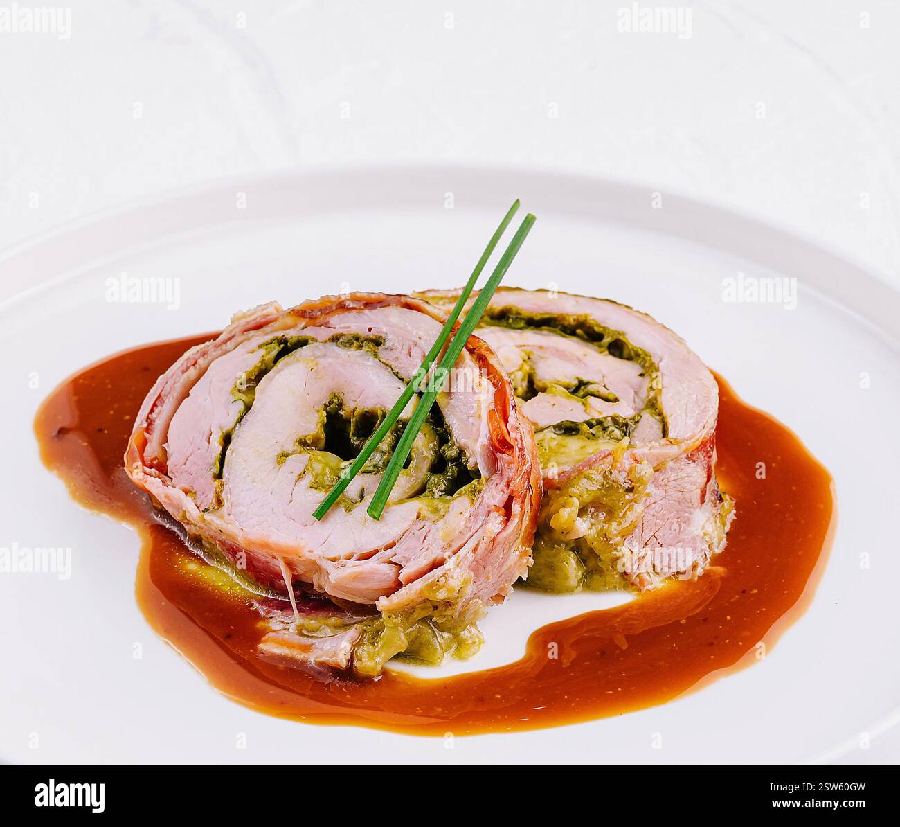 Gourmet stuffed pork roulade with savory sauce Stock Photo - Alamy