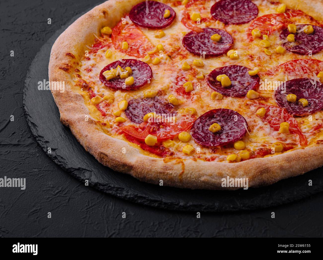 Appetizing pepperoni pizza on black background Stock Photo - Alamy
