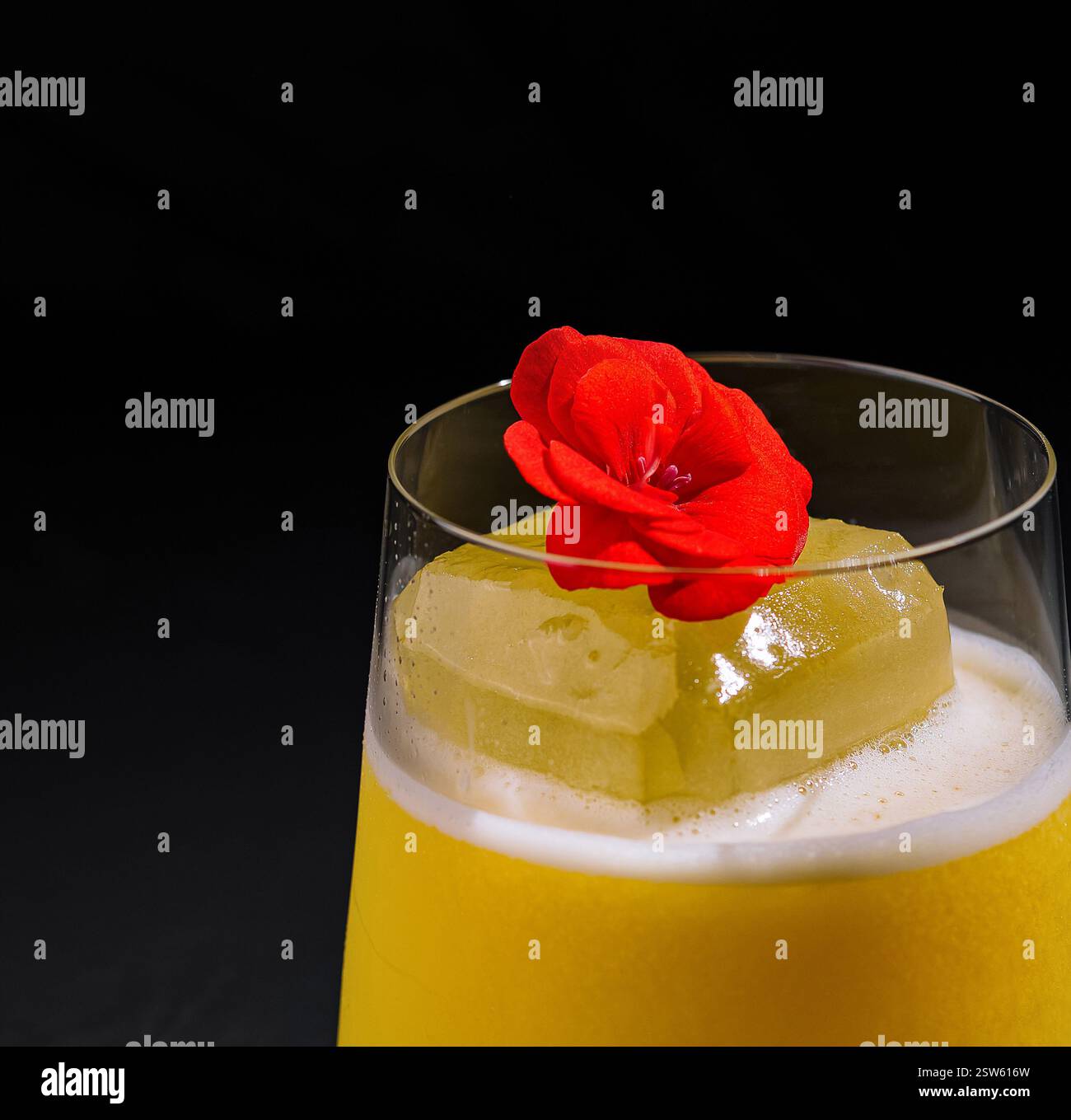 Elegant cocktail with edible flower garnish Stock Photo - Alamy