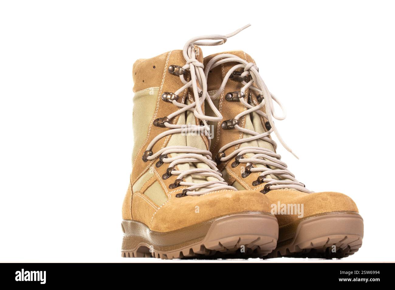 Detailed view of a pair of sturdy brown military boots. Features ...