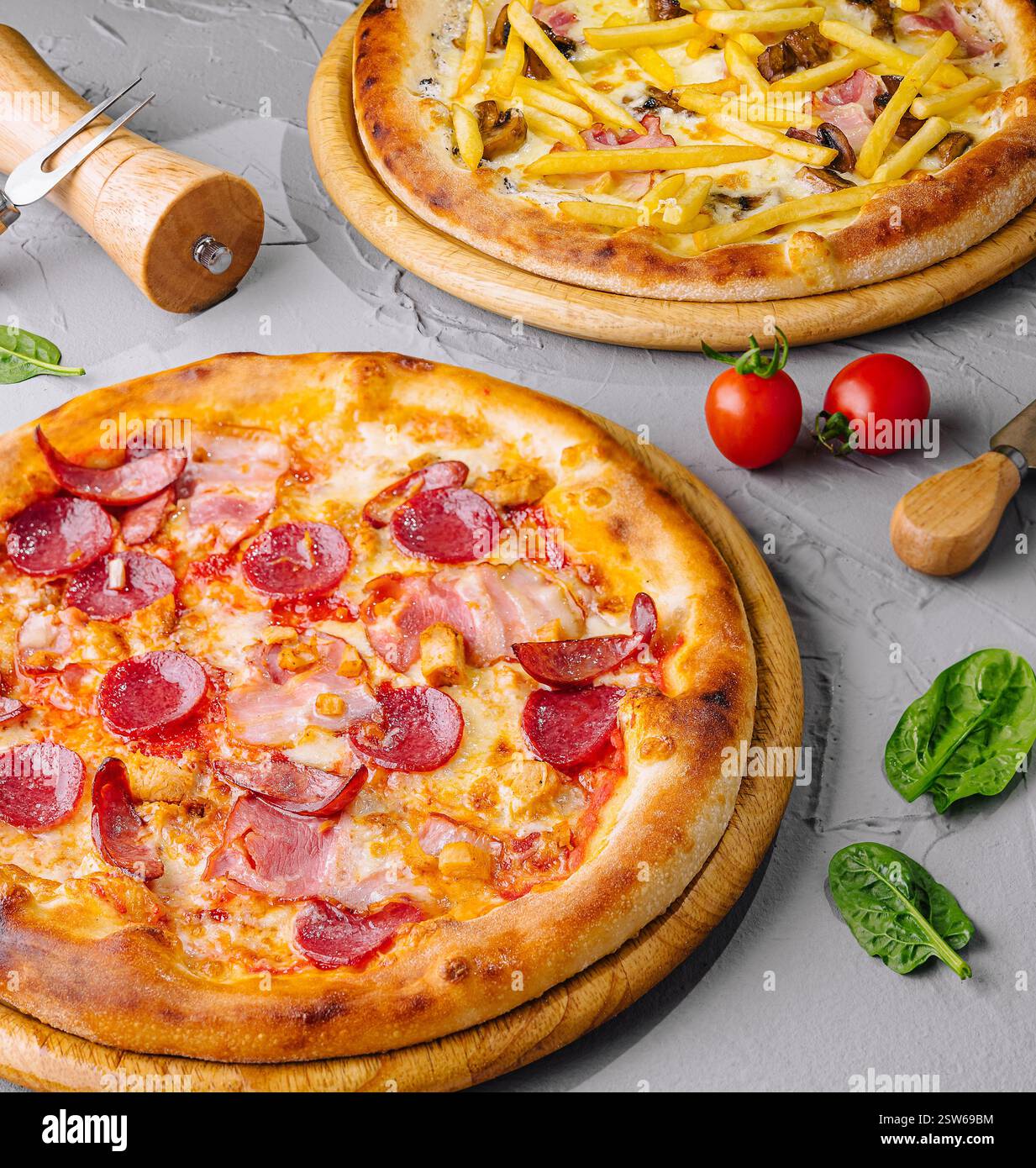 Gourmet pizzas with toppings on elegant table setting Stock Photo - Alamy