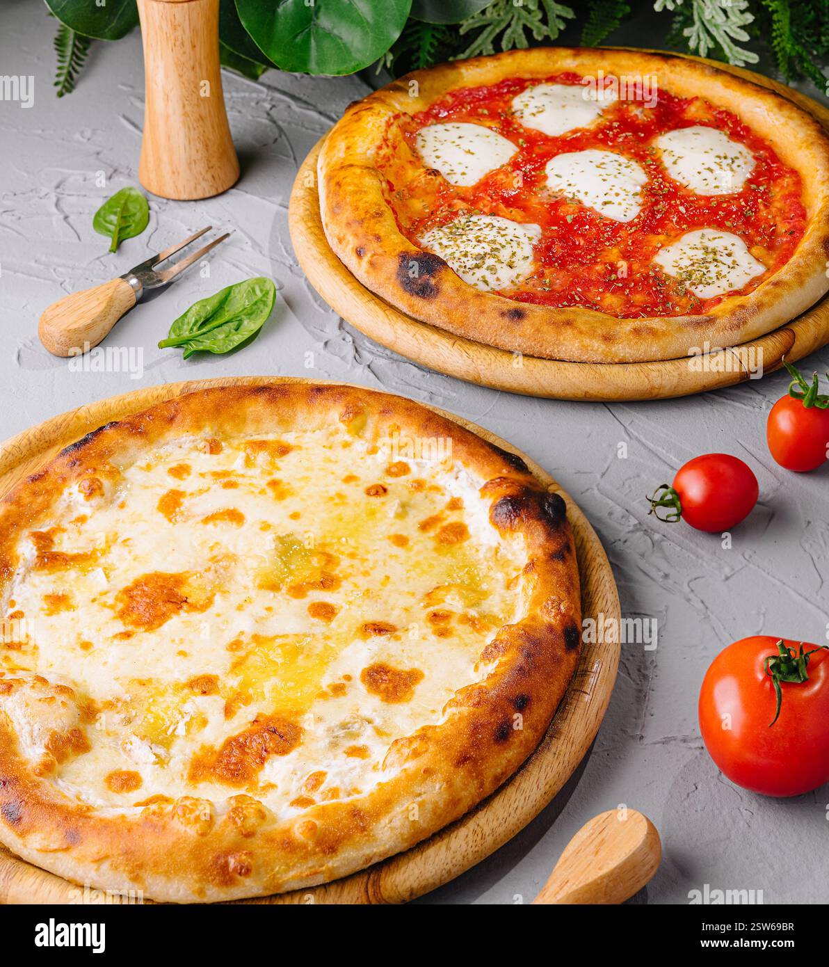 Gourmet margherita and cheese pizzas on rustic table Stock Photo - Alamy