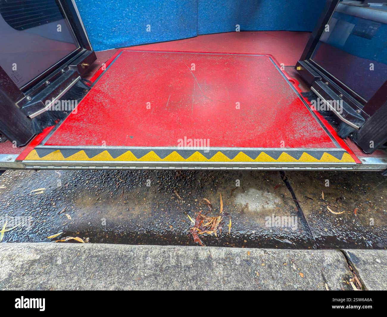 Photograph of a well used floor at the entry to a commercial transit ...