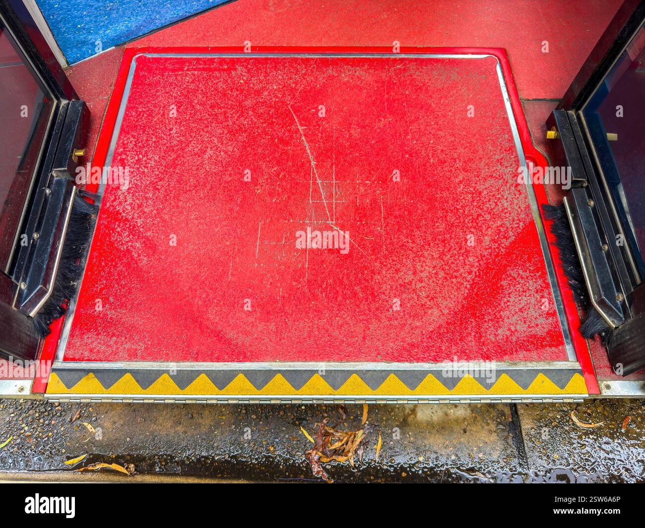Photograph of a well used floor at the entry to a commercial transit ...
