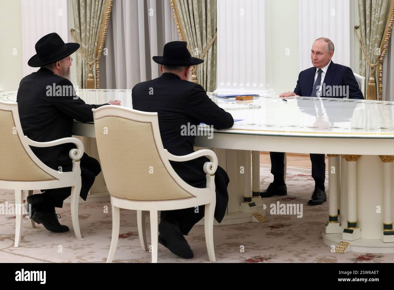 Russian President Vladimir Putin, right, listens to Chief Rabbi of ...