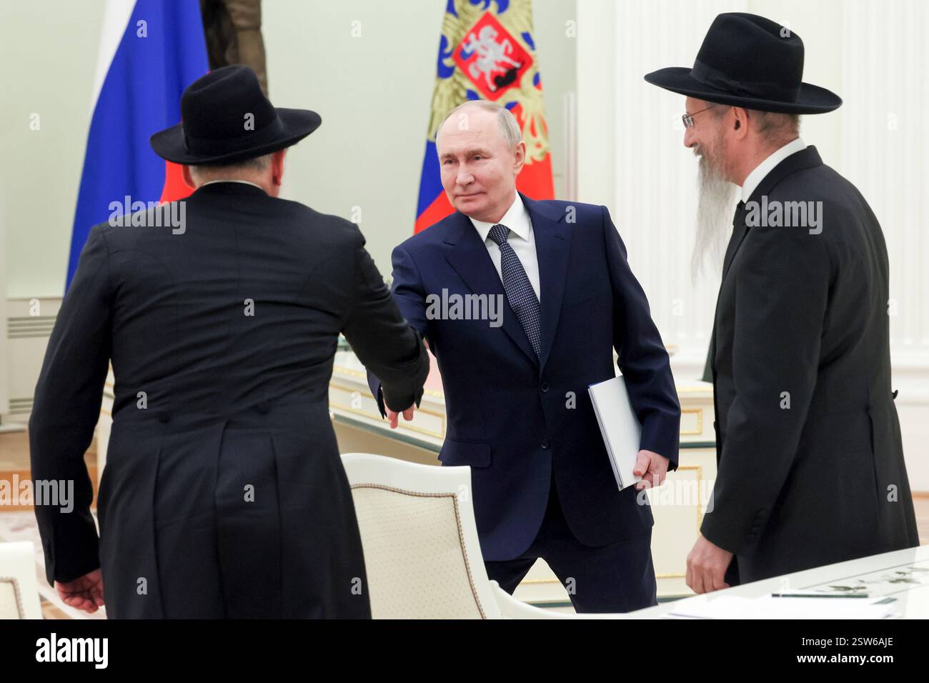 Russian President Vladimir Putin, center, greets Chief Rabbi of Russia ...