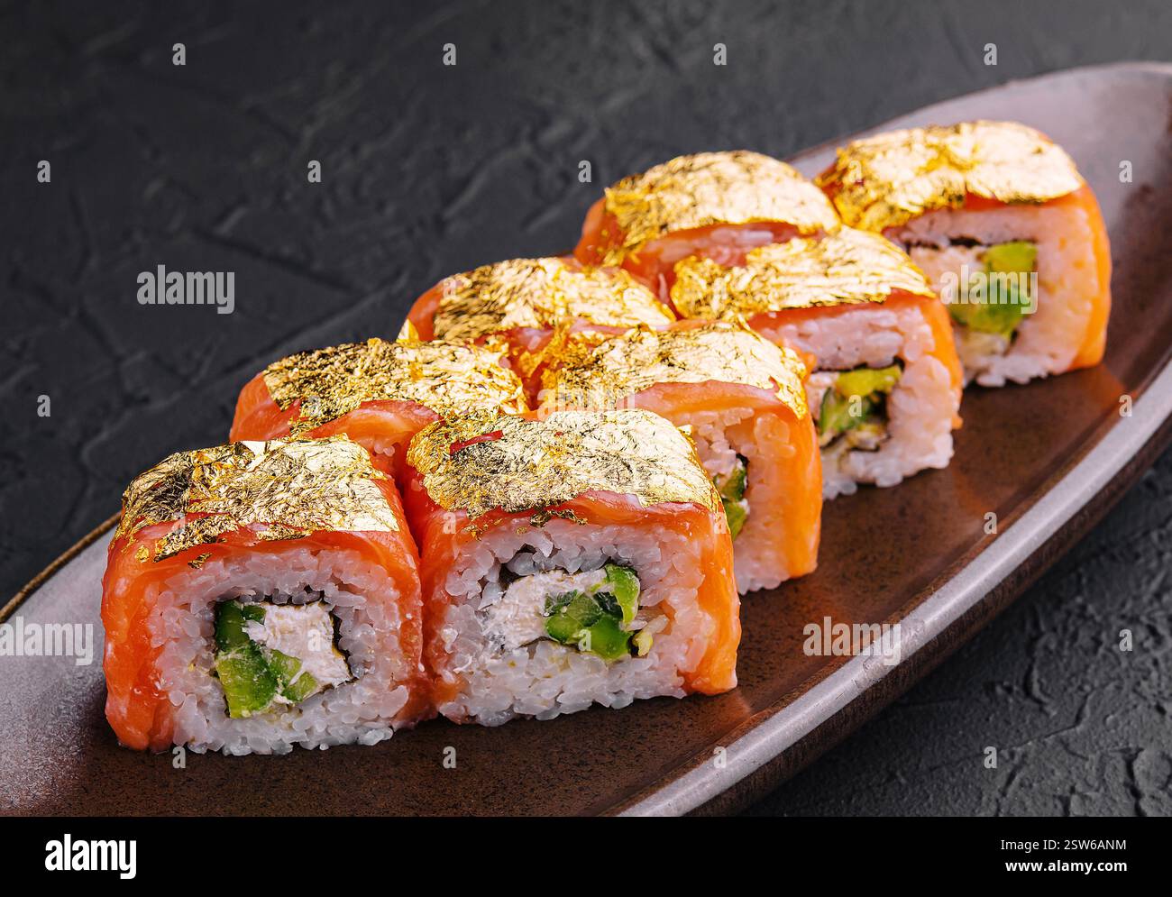 Luxury gold leaf sushi rolls on dark plate Stock Photo - Alamy