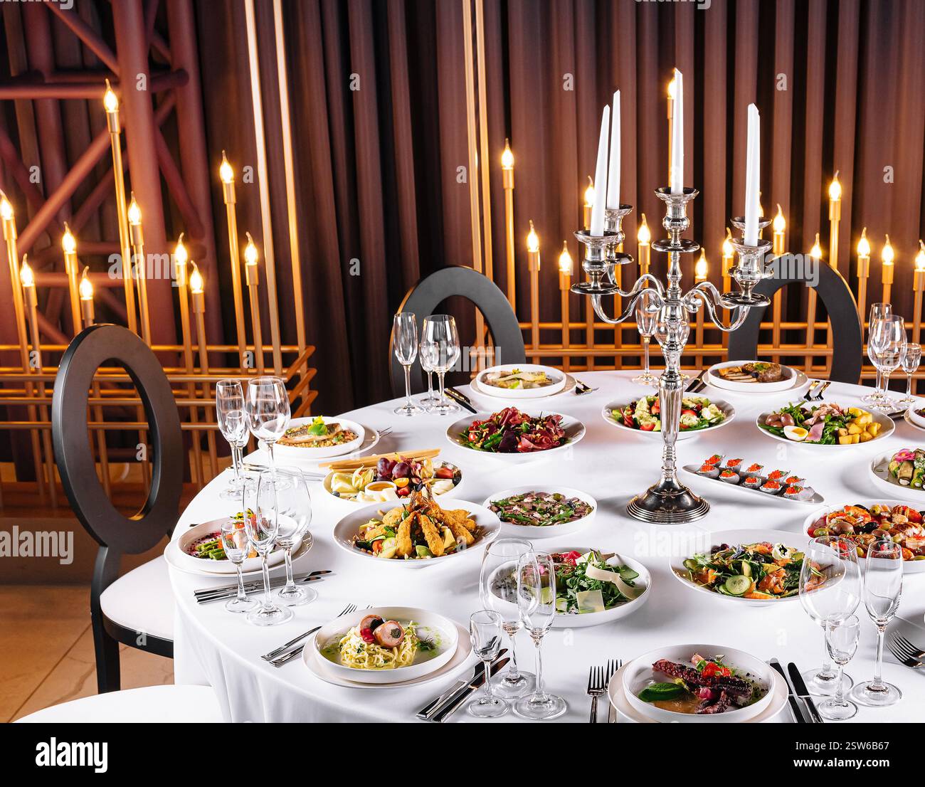Luxurious dinner spread on a round white table in a posh restaurant ...