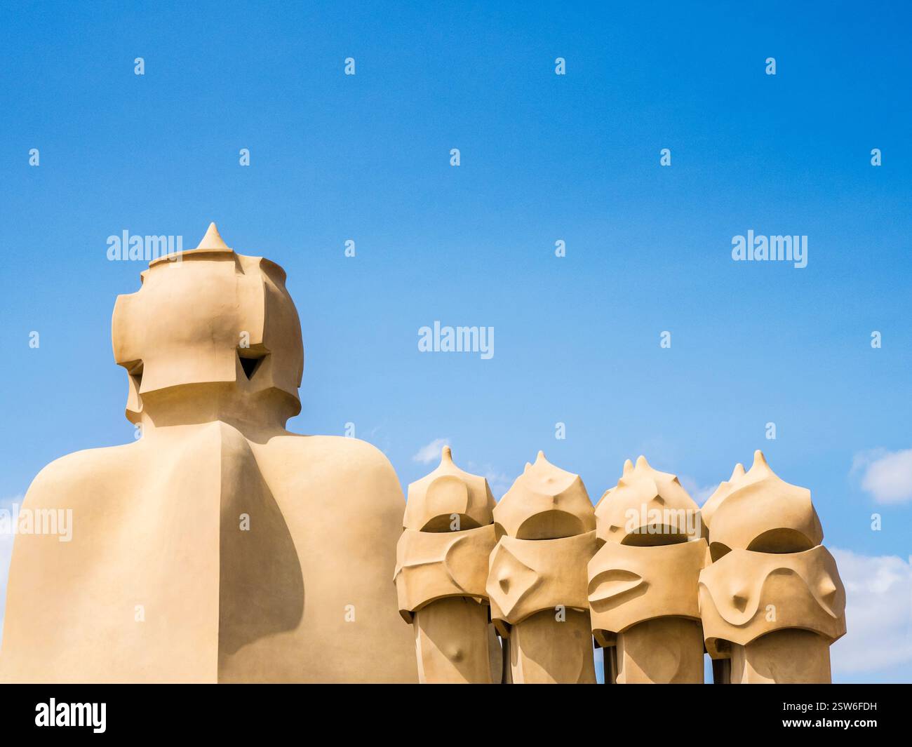 A group of six chimneys by a stairwell on the roof terrace of Casa Mila ...