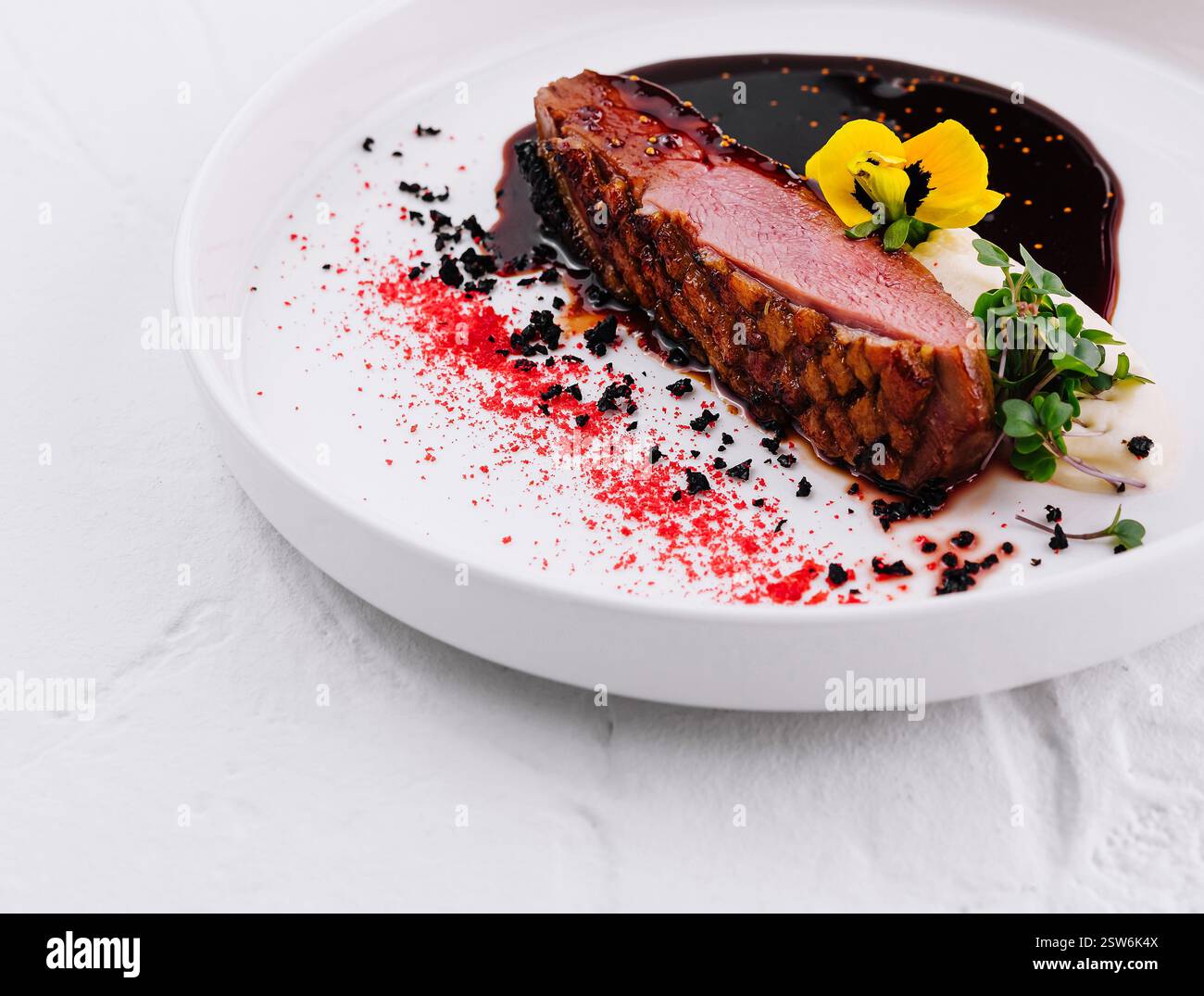 Elegant plated beef steak with a rich red wine sauce, garnished with ...