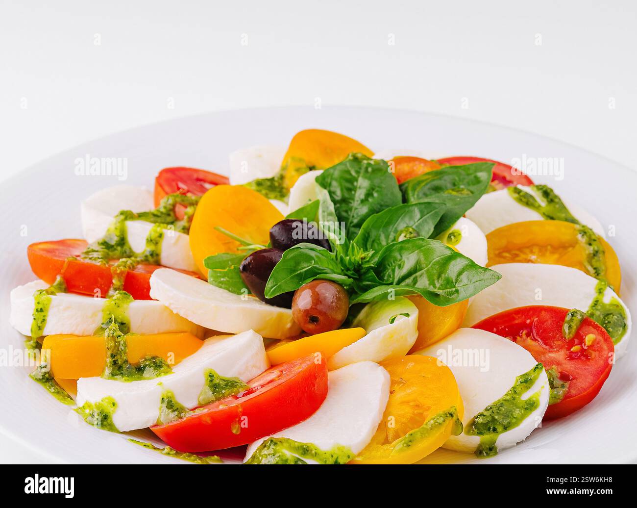 Basil and pesto dressing on a white plate hi-res stock photography and ...