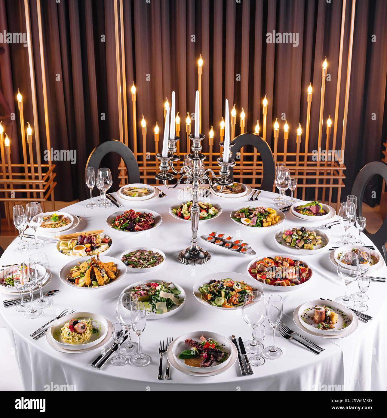 Elegant dinner table with gourmet dishes and candlelight Stock Photo - Alamy