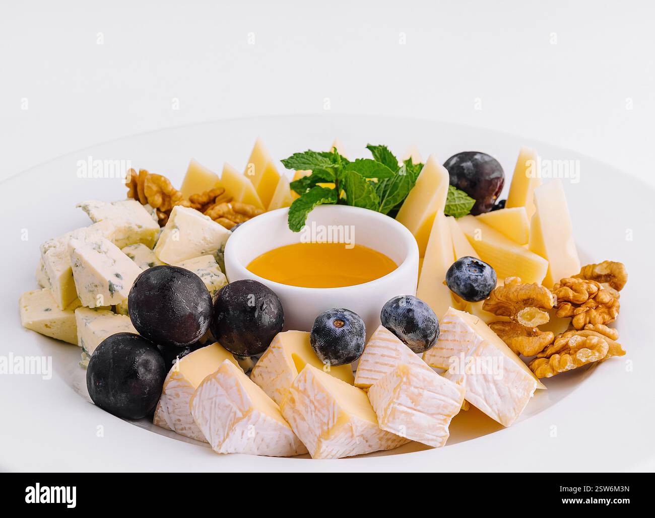 Gourmet cheese platter with honey and fruits Stock Photo - Alamy