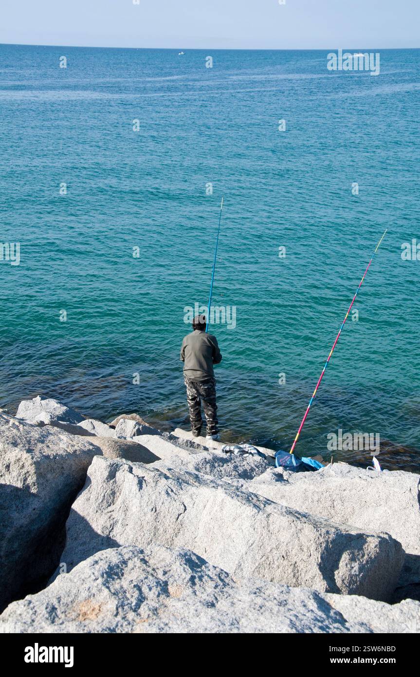 Fishing with rod in the breakwater, Picordia beach, Arenys de Mar ...